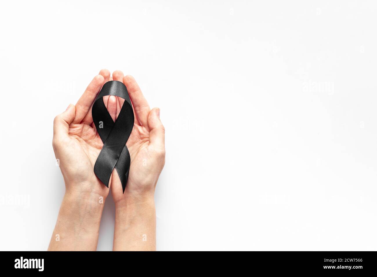 Hands holding black ribbon, top view. Funeral symbol Stock Photo - Alamy