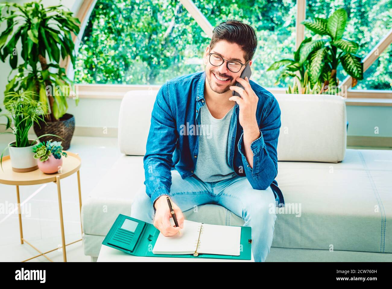 High angle shot of happy businessman using phone and talking with ...