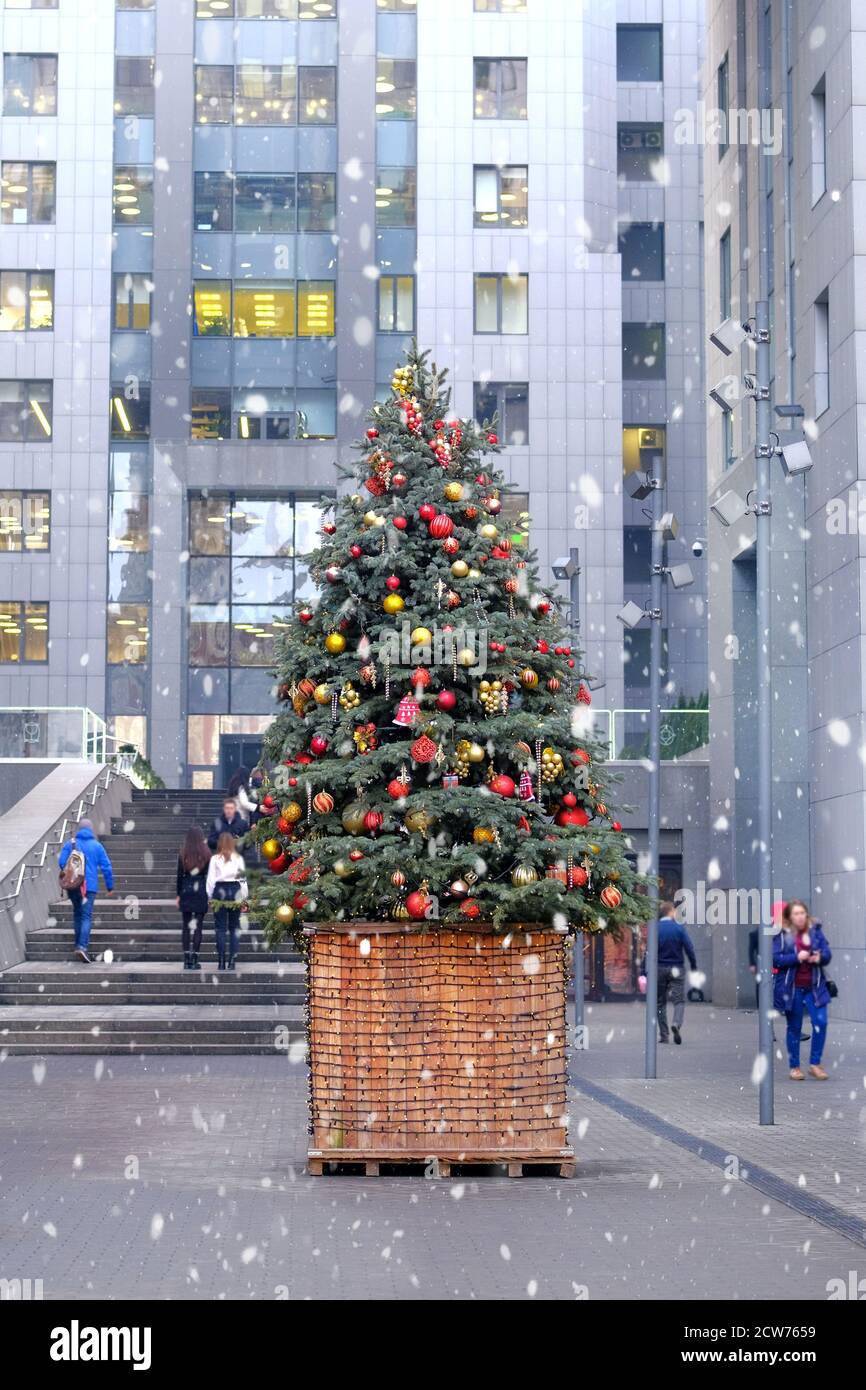 Christmas tree decorated with bright balls and toys stands in front of ...