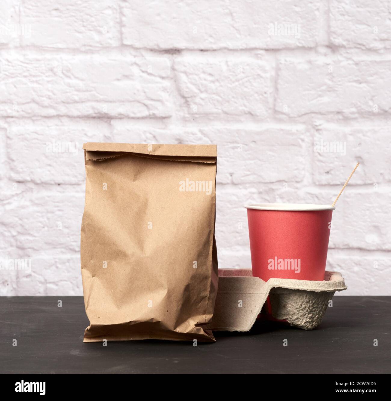 red paper disposable cups stand in the tray, white background, takeaway ...