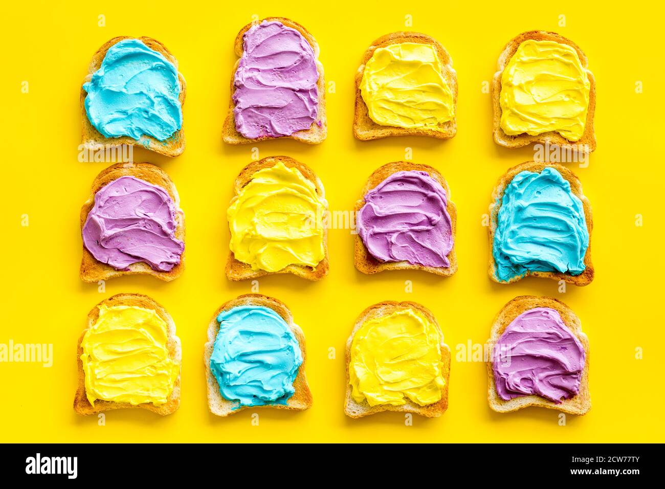 Pattern of toast bread with colored cheese spread. Layout top view ...