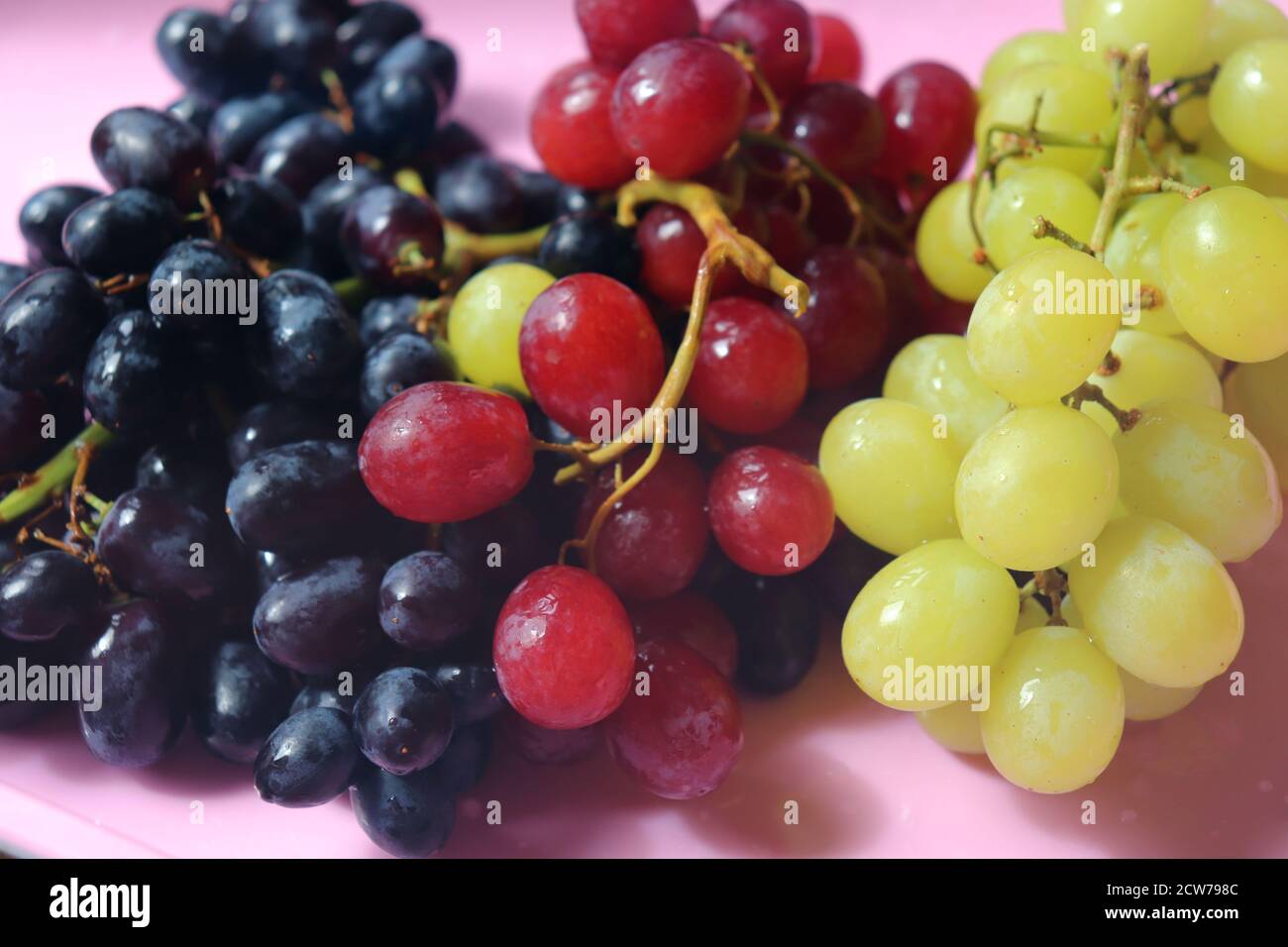 Selection of fresh grapes in different colours, ready to be eaten for a ...