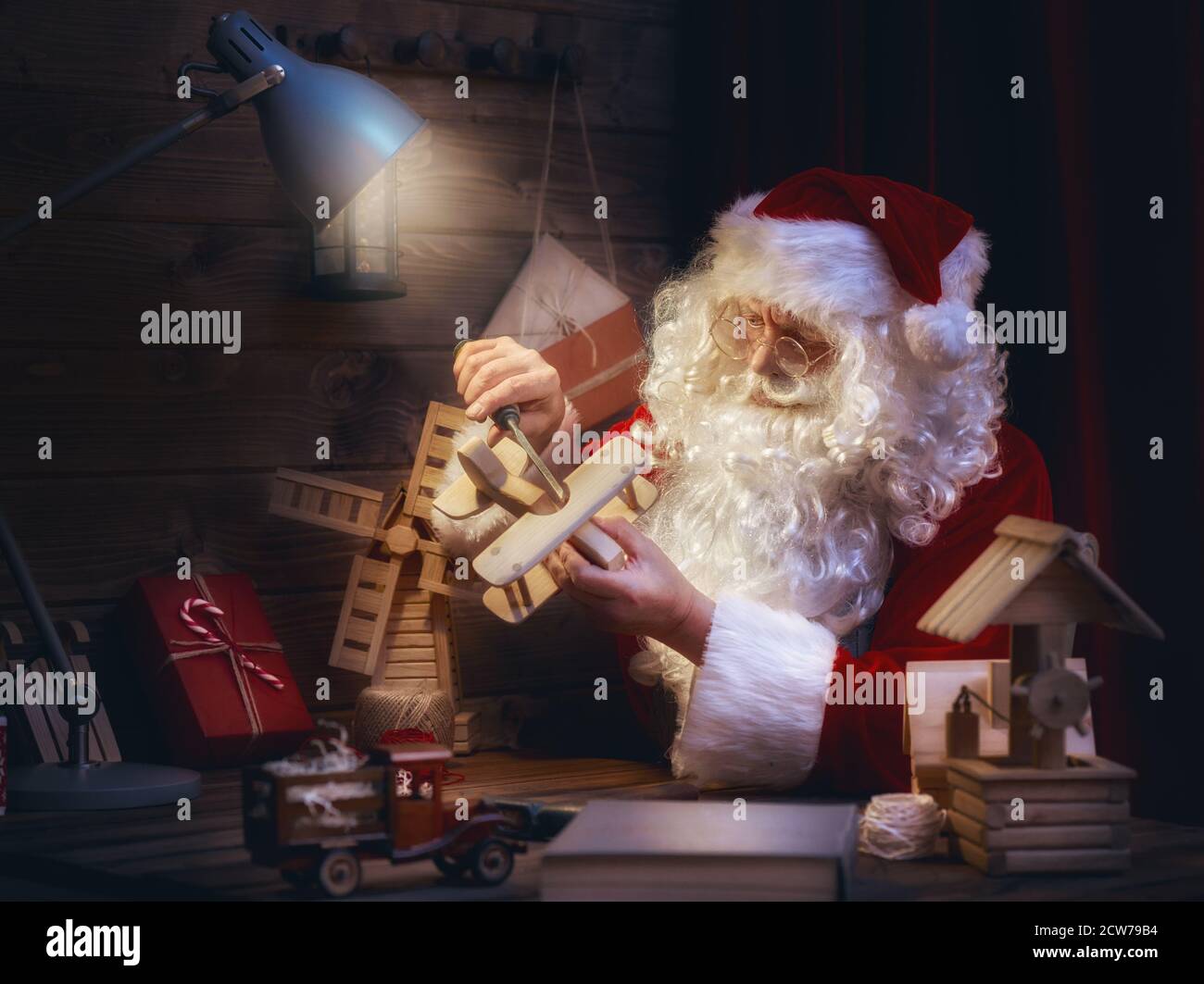 Merry Christmas and Happy Holidays! Santa Clause is preparing gifts for ...