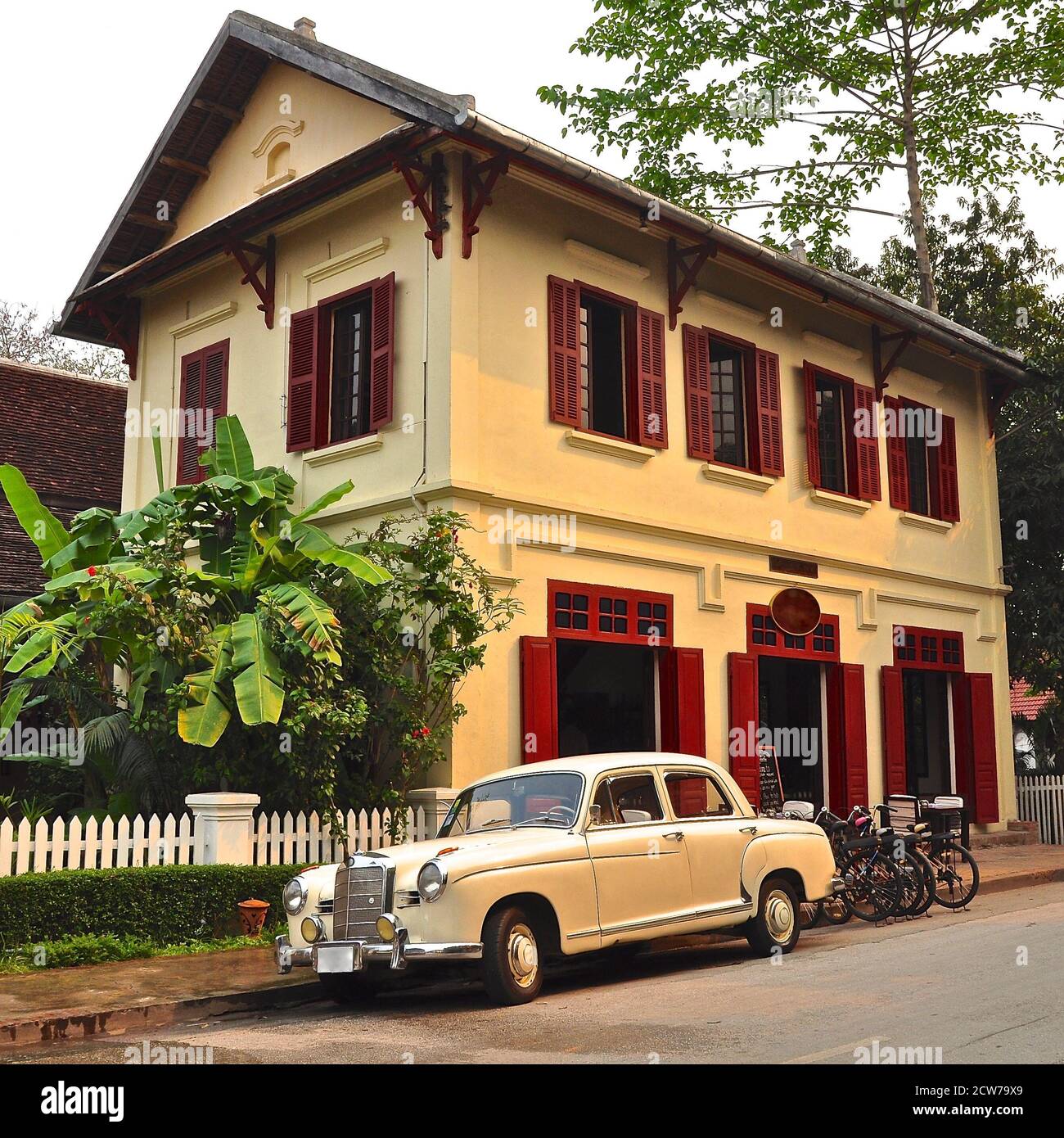 Luxury cream vintage car parked outside a colonial building with red ...