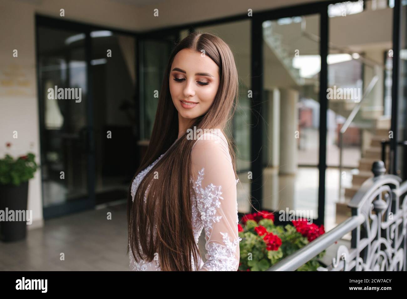 Beautiful young model in evening drees posing to photographer Stock ...