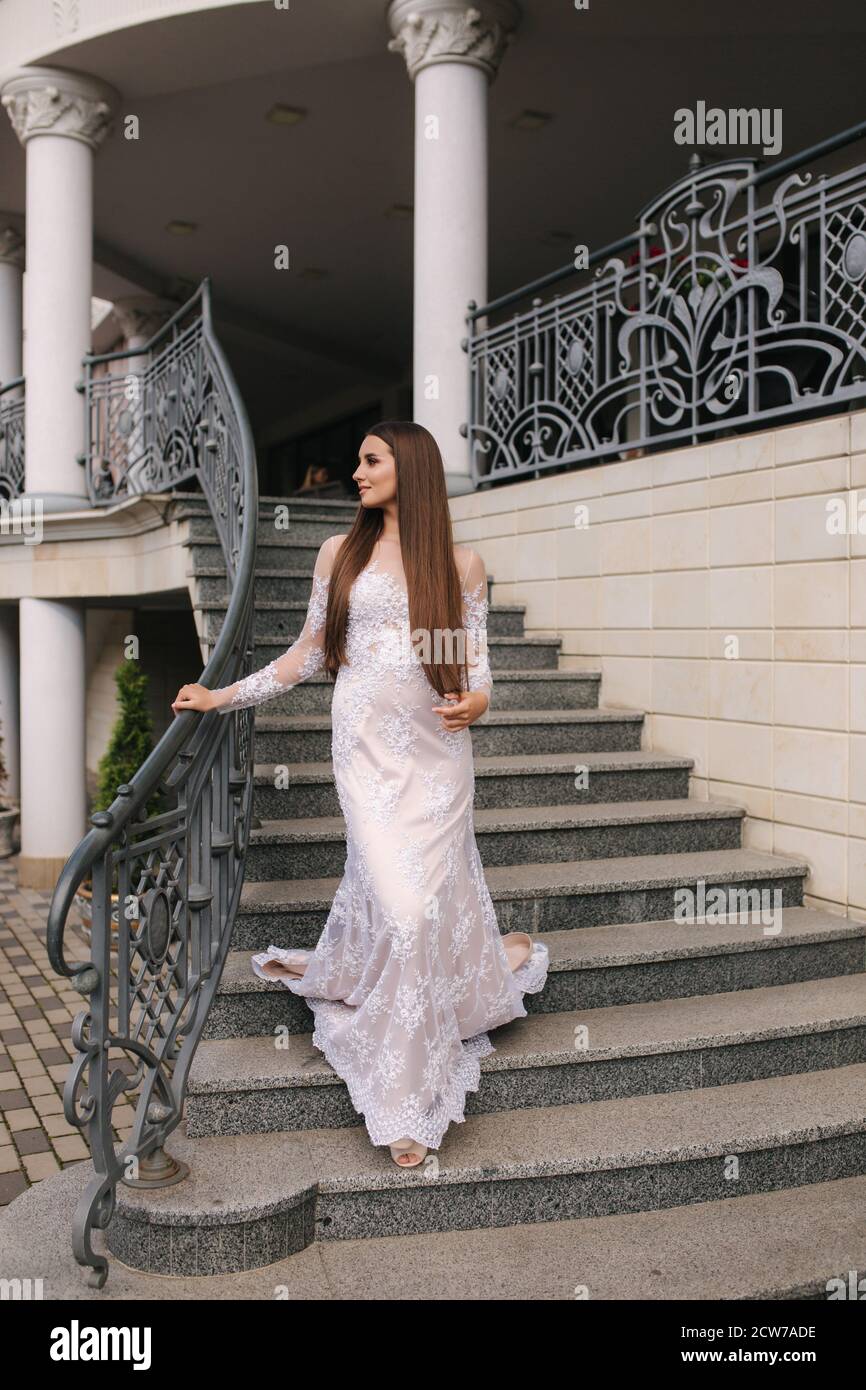 Gorgeous model in wedding dress stand on stair by big restaurant Stock ...