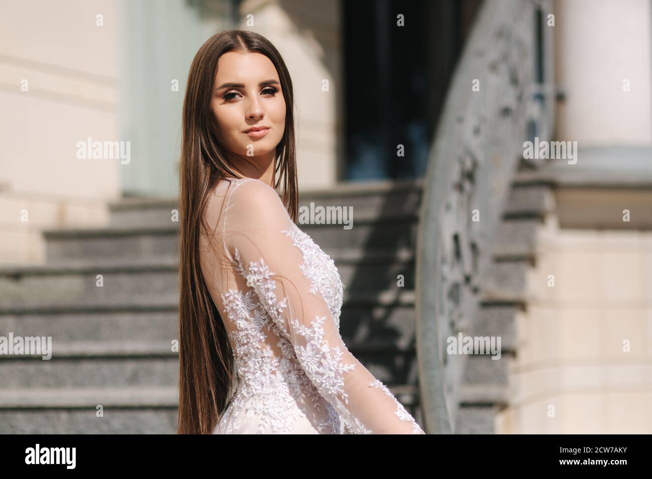 Gorgeous model in wedding dress stand on stair by big restaurant Stock ...