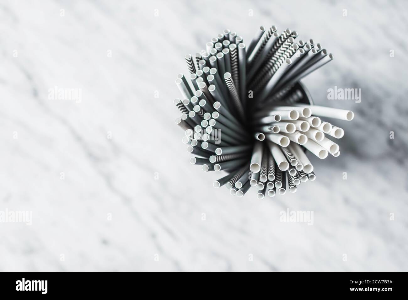 Set of different paper drinking straws on gray concrete background in ...