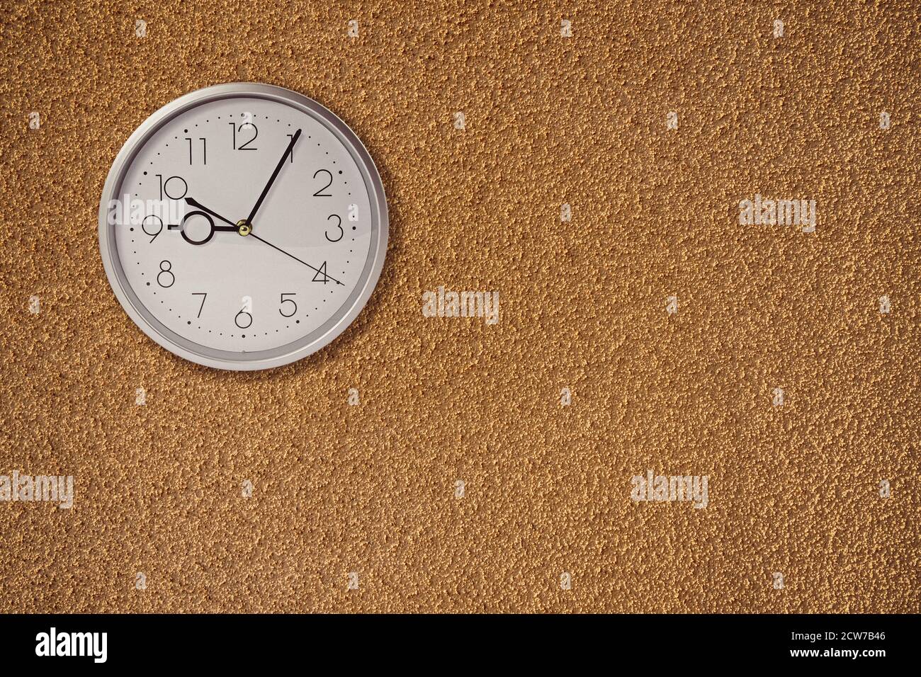Stylish analog clock hanging on a painted wall, space for text Stock ...