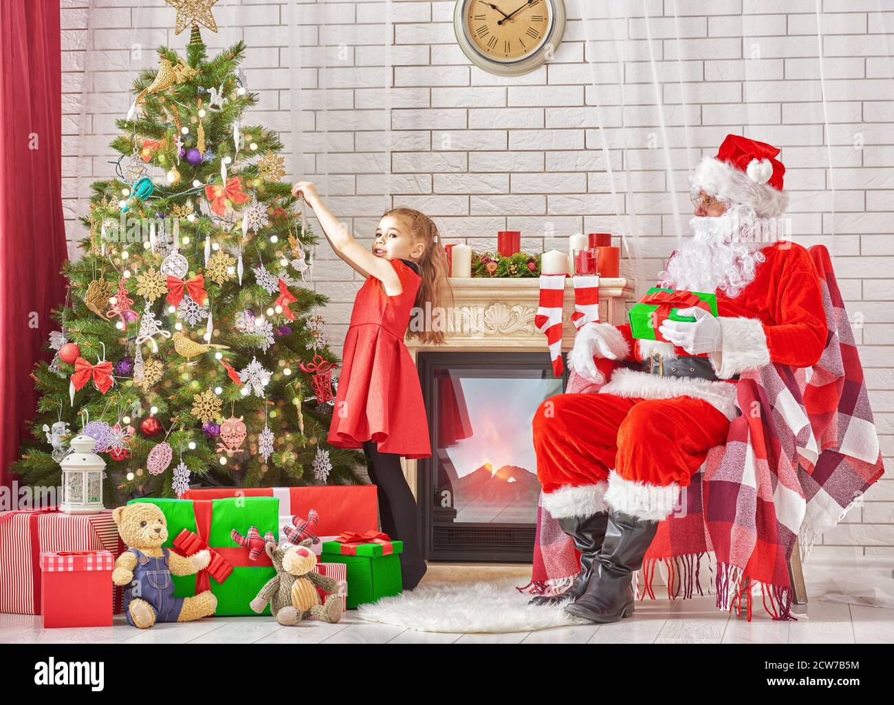Santa Claus and cute girl getting ready for Christmas Stock Photo - Alamy