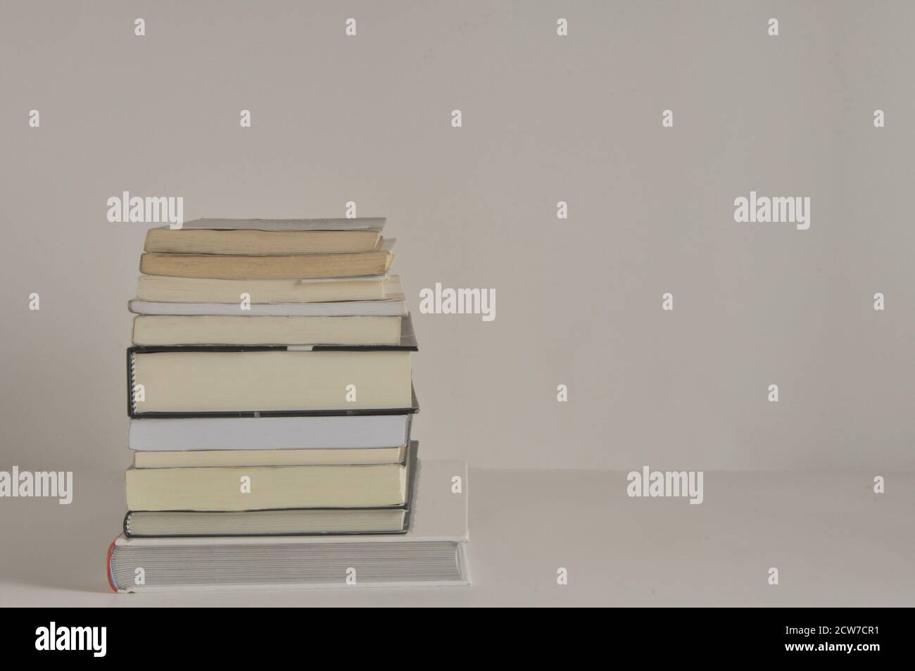 Stack of books, books of various themes, side view, white background ...