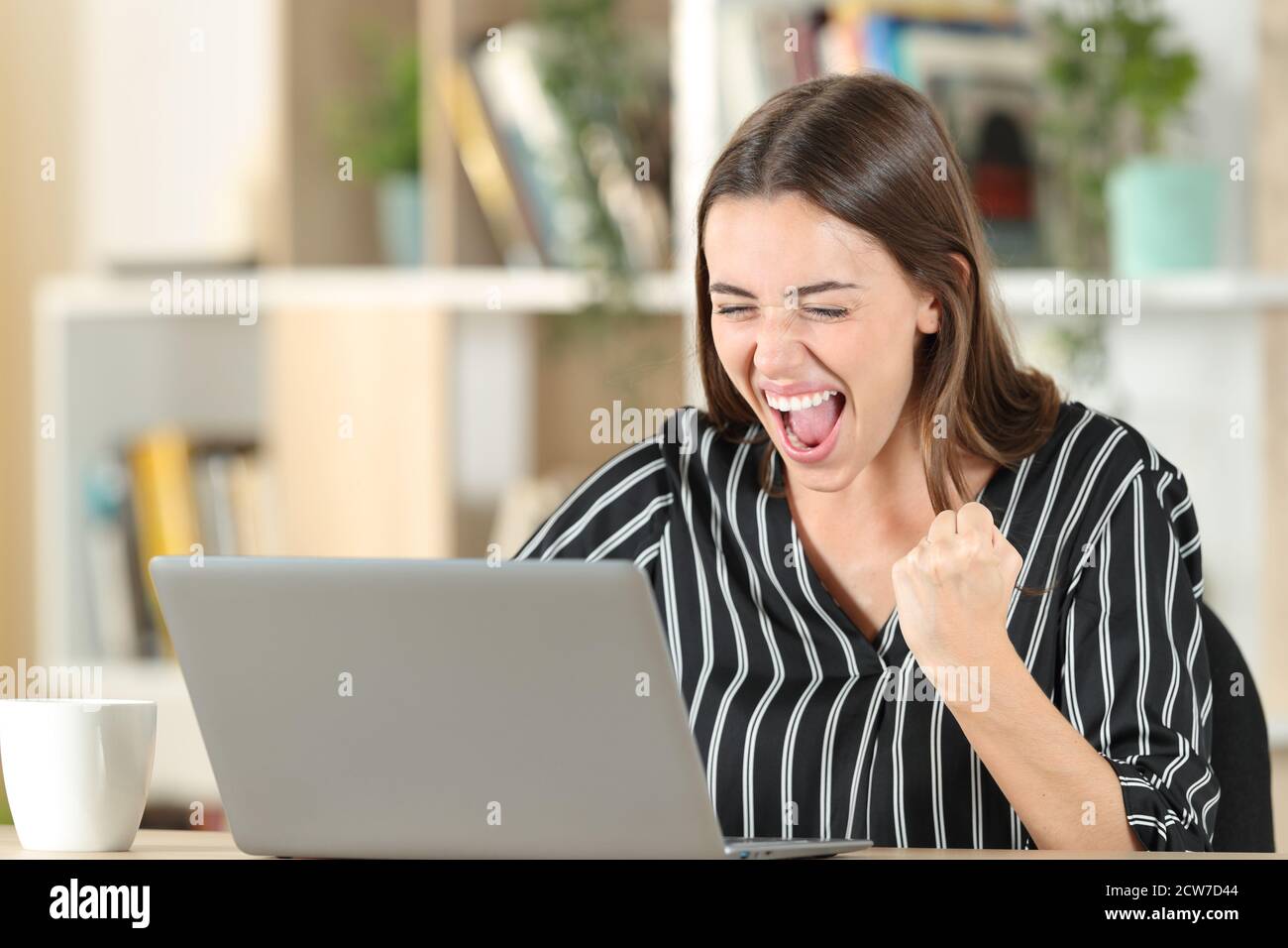 Excited woman computer home hi-res stock photography and images - Alamy