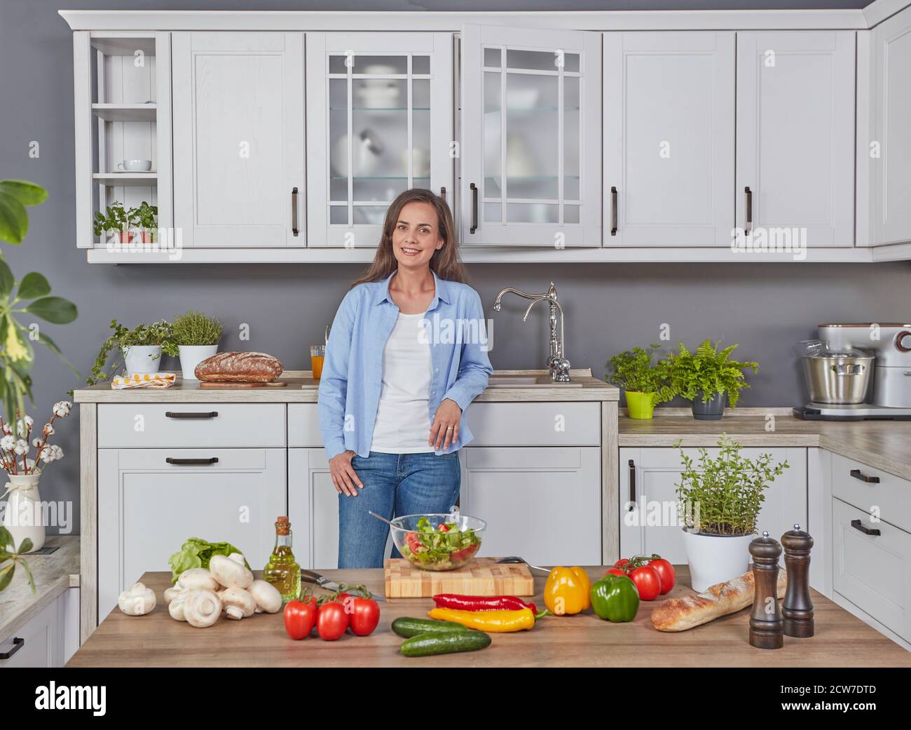 Beautiful woman preparing dinner in kitchen Stock Photo - Alamy