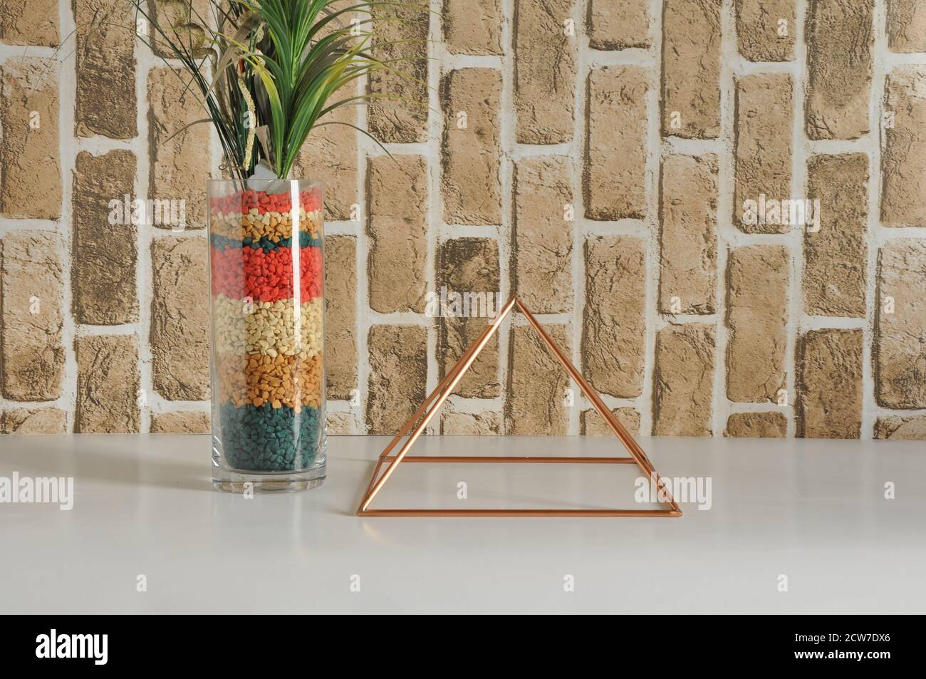 Copper pyramid. pyramid with glass vase and artificial flower ...