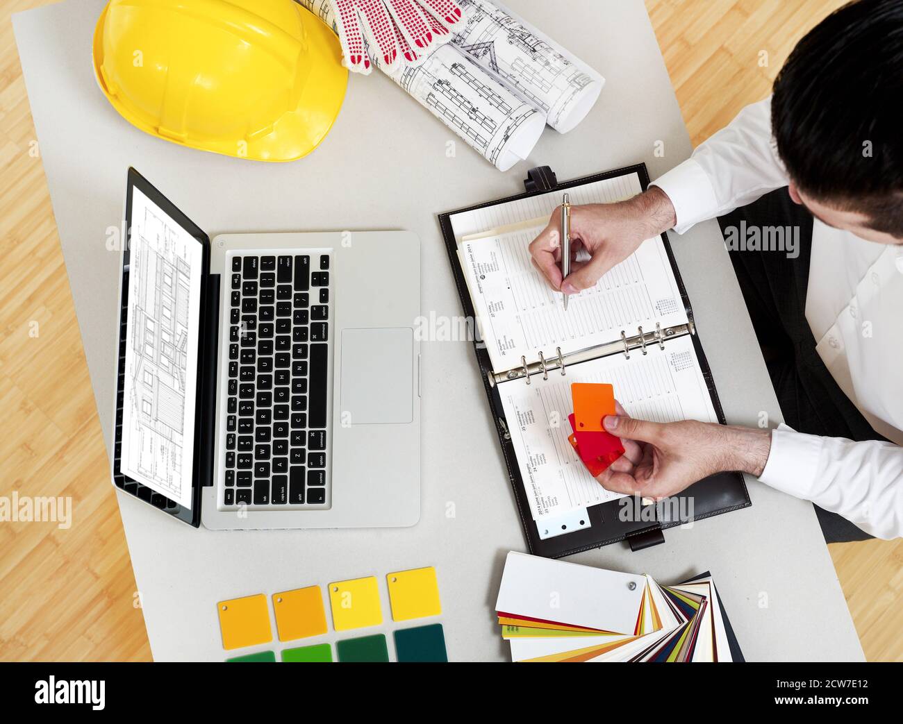 Man with color swatches at desk Stock Photo - Alamy