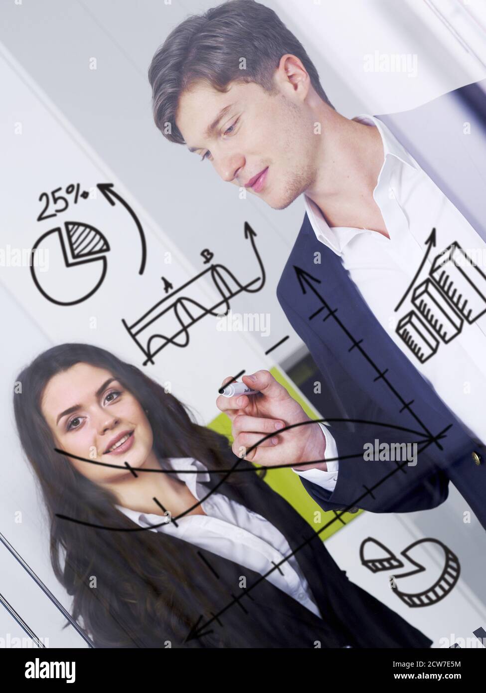 Co-workers drawing on whiteboard Stock Photo - Alamy
