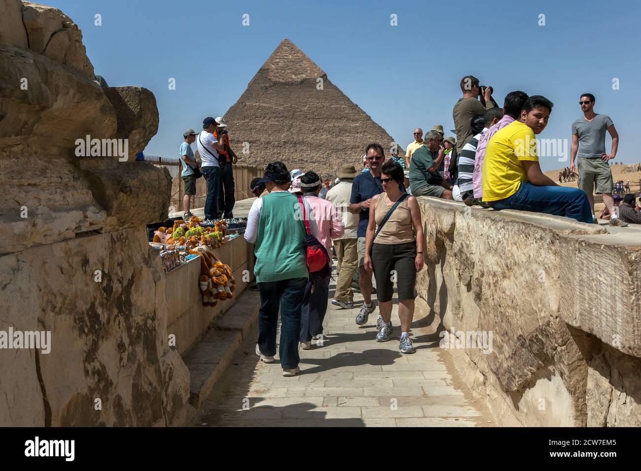 A crowd of tourists to Giza in Cairo, Egypt gather near the base of the ...