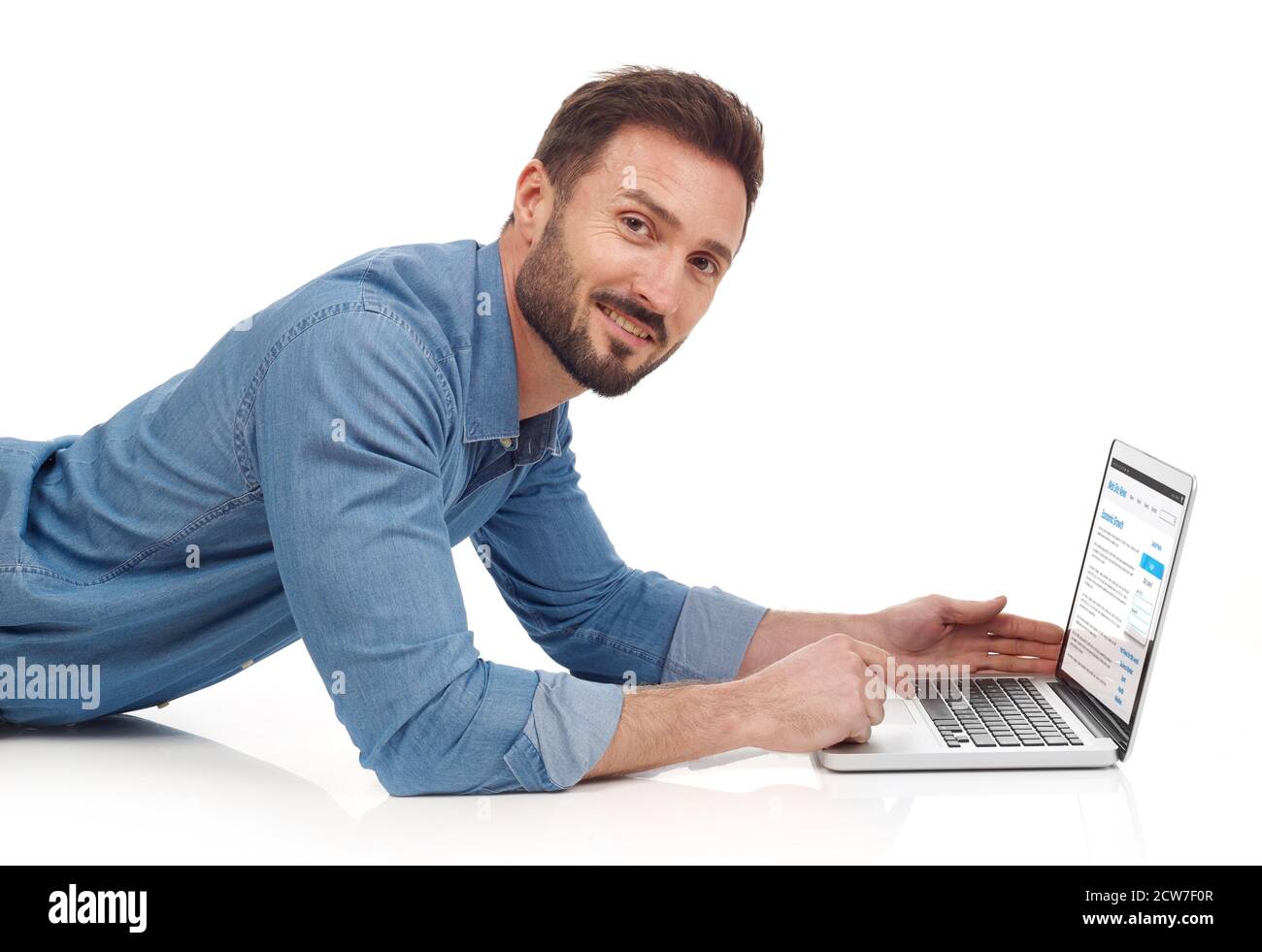 Man with laptop looking at camera, white background Stock Photo - Alamy