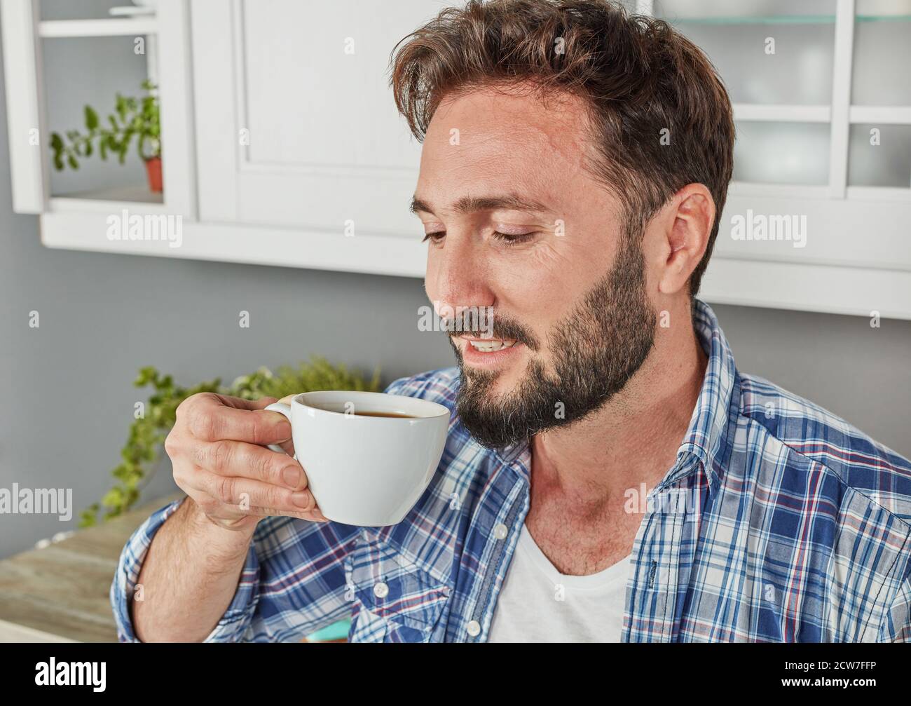 Cheerful man enjoying a coffee Stock Photo - Alamy