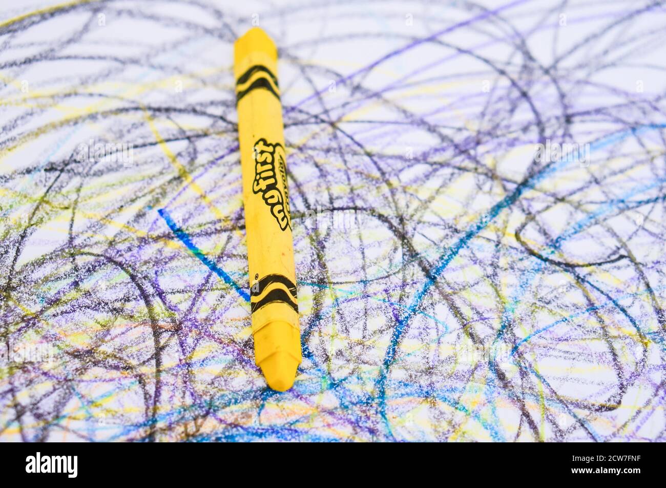 POZNAN, POLAND - May 14, 2016: Yellow Crayon drawing stick on a white ...