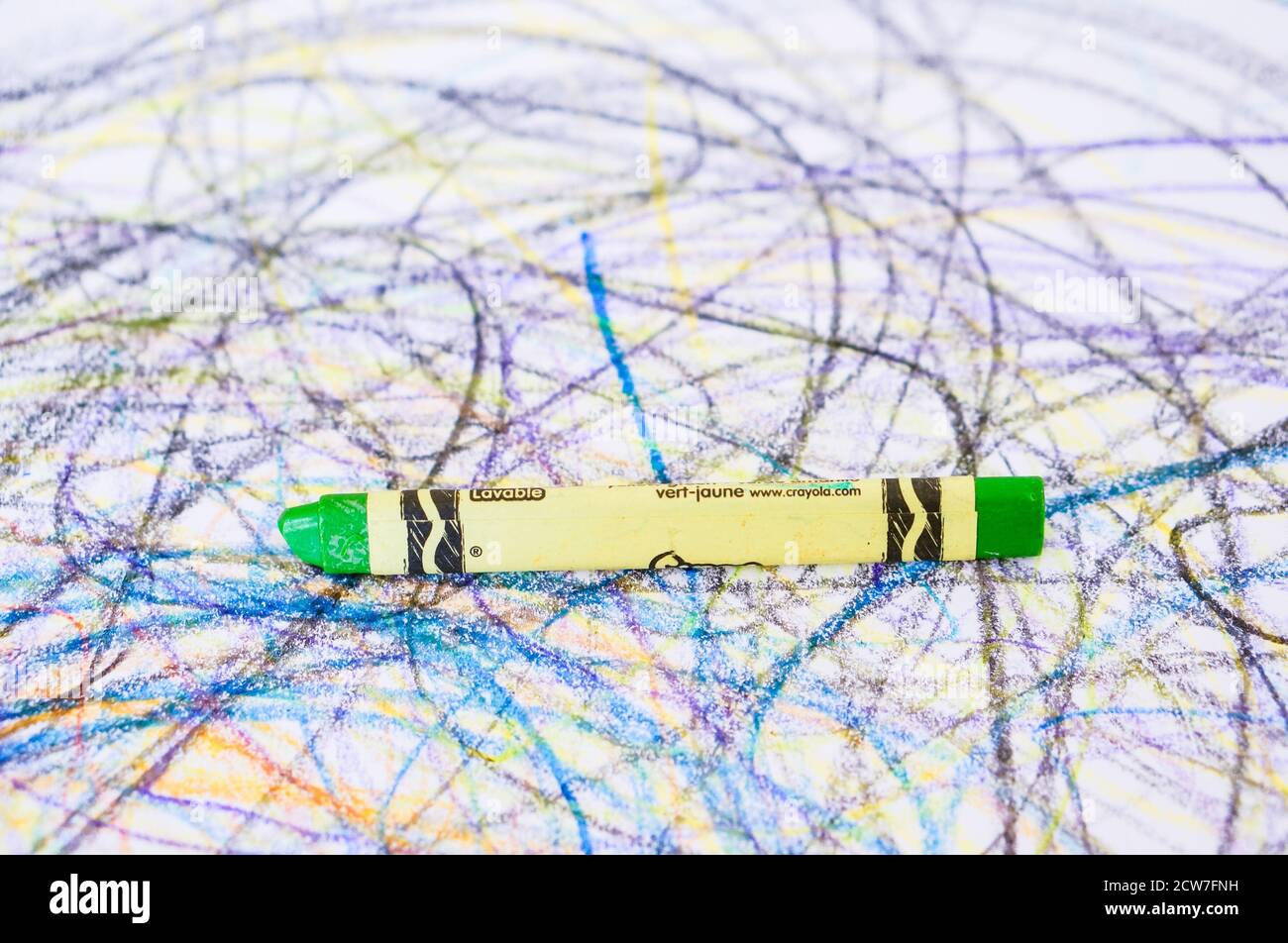POZNAN, POLAND - May 14, 2016: Green Crayon drawing stick on a white ...
