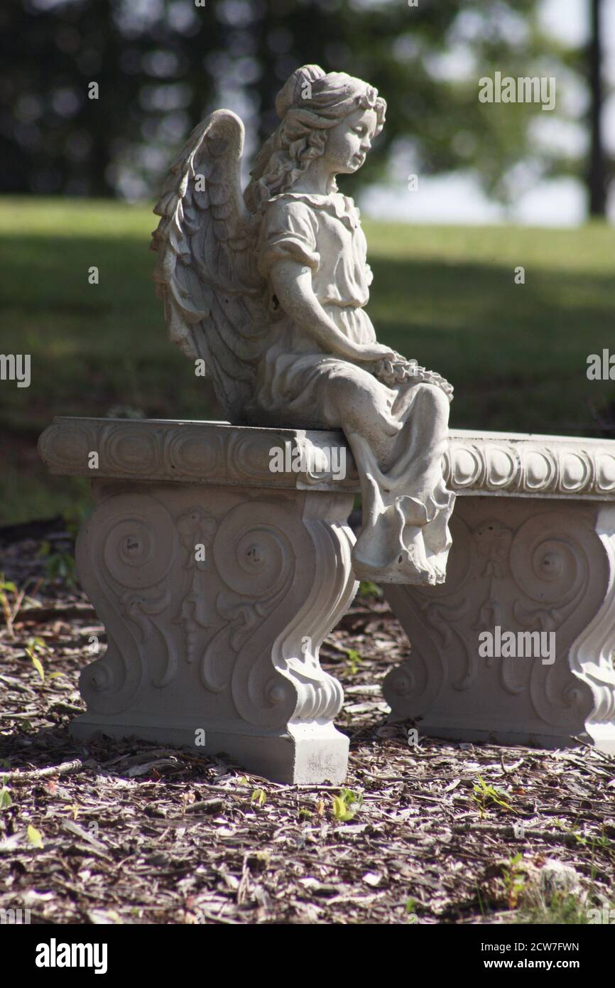 Angel on bench- yard decor Stock Photo - Alamy