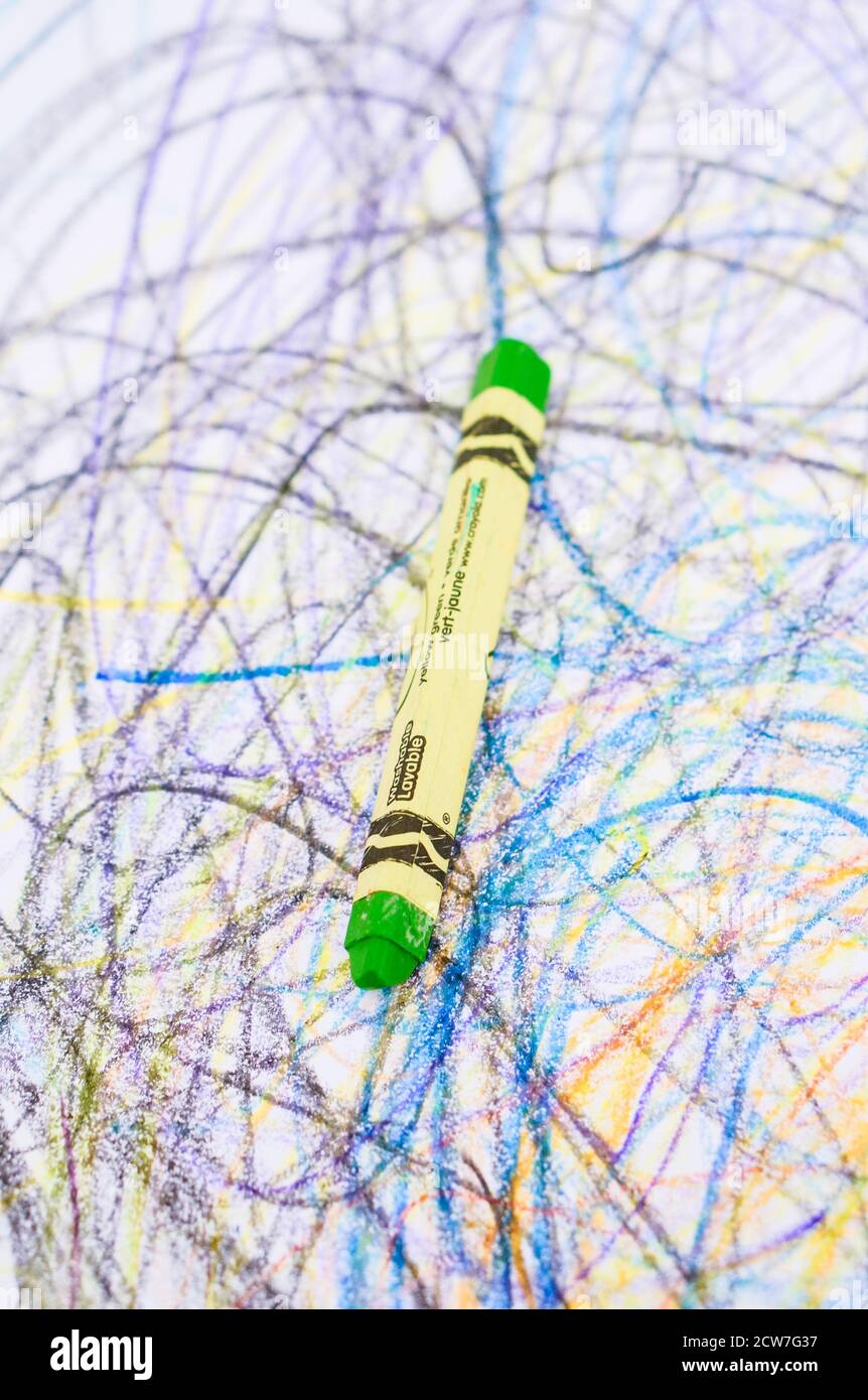 POZNAN, POLAND - May 14, 2016: Green Crayon drawing stick on a white ...