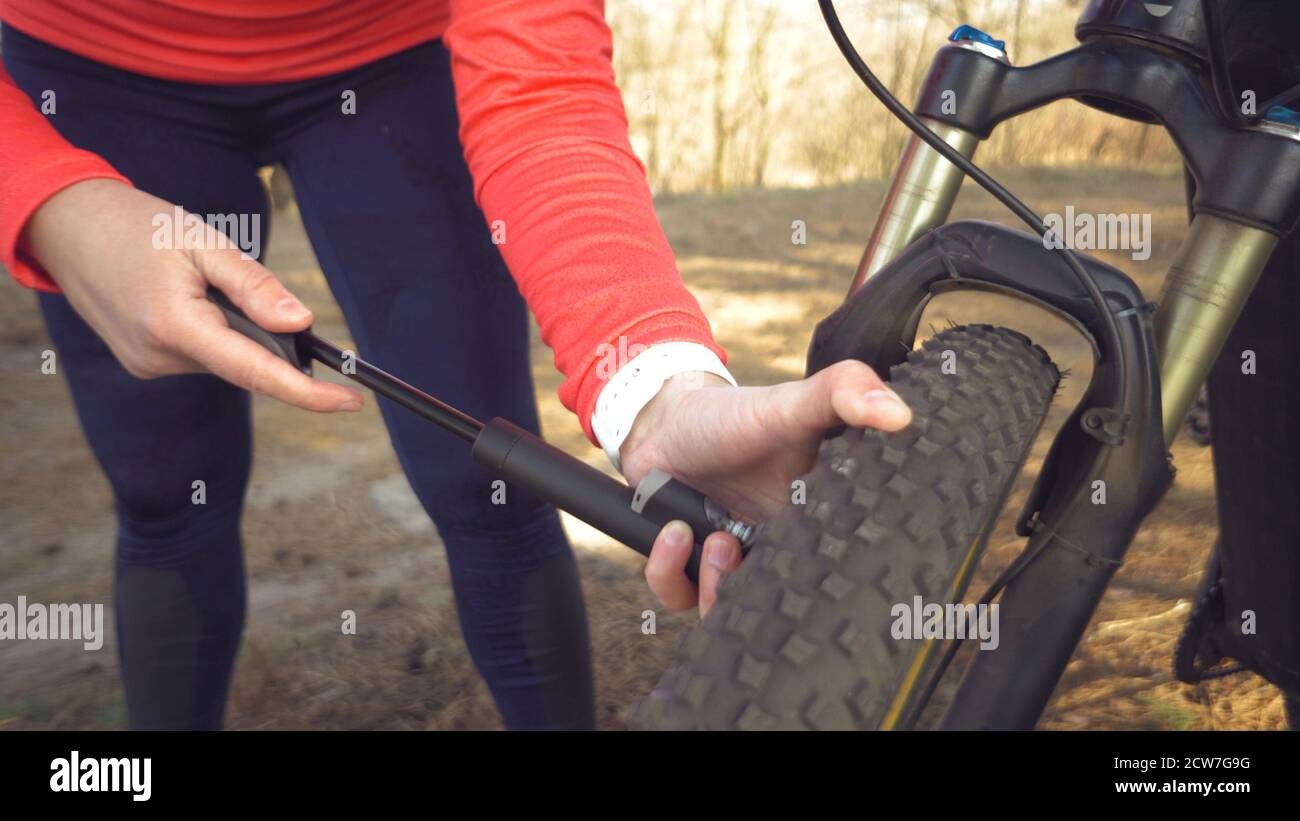 Woman pumping up air pump hi-res stock photography and images - Alamy