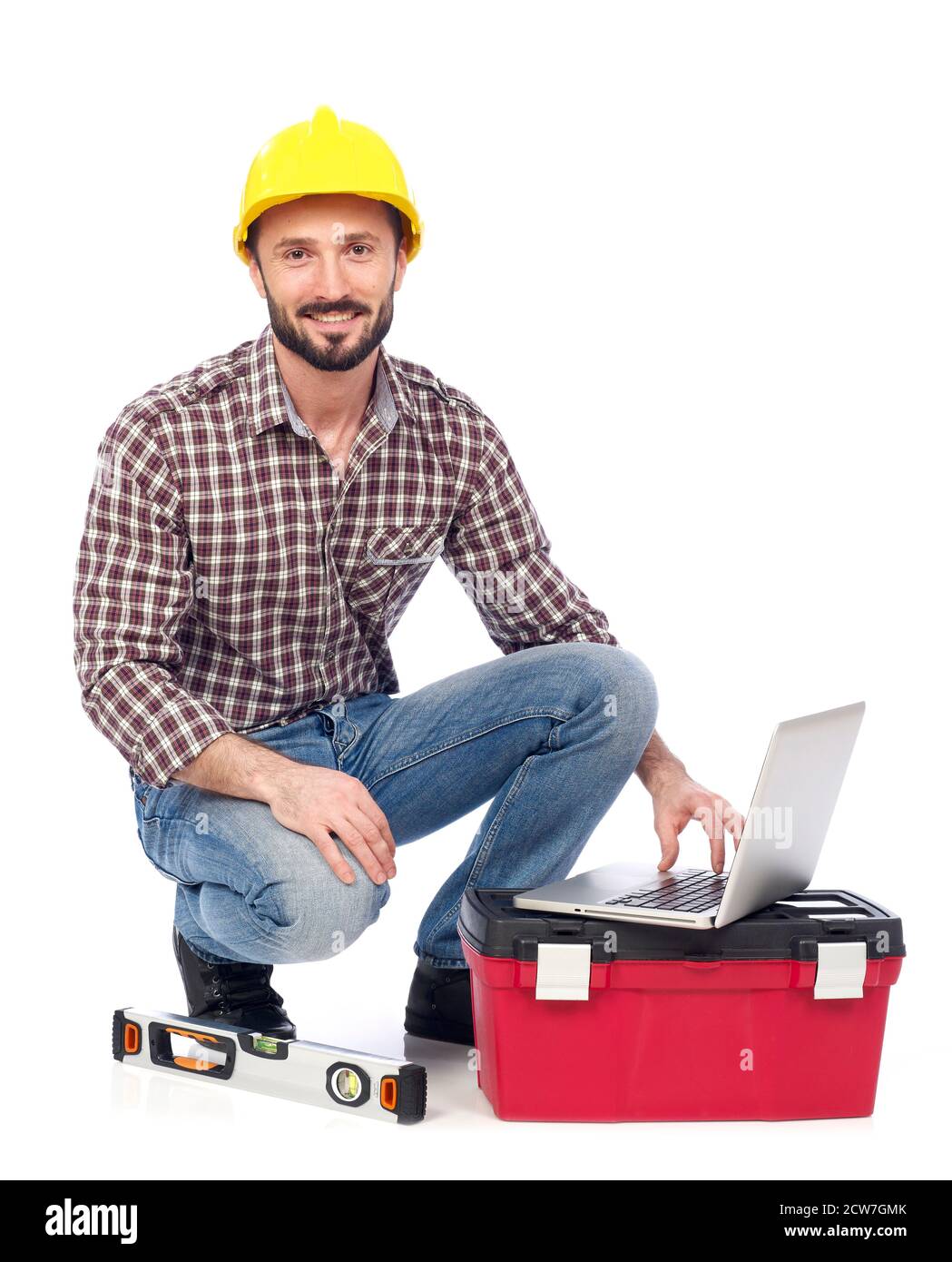 Carpenter working on laptop, white background Stock Photo - Alamy