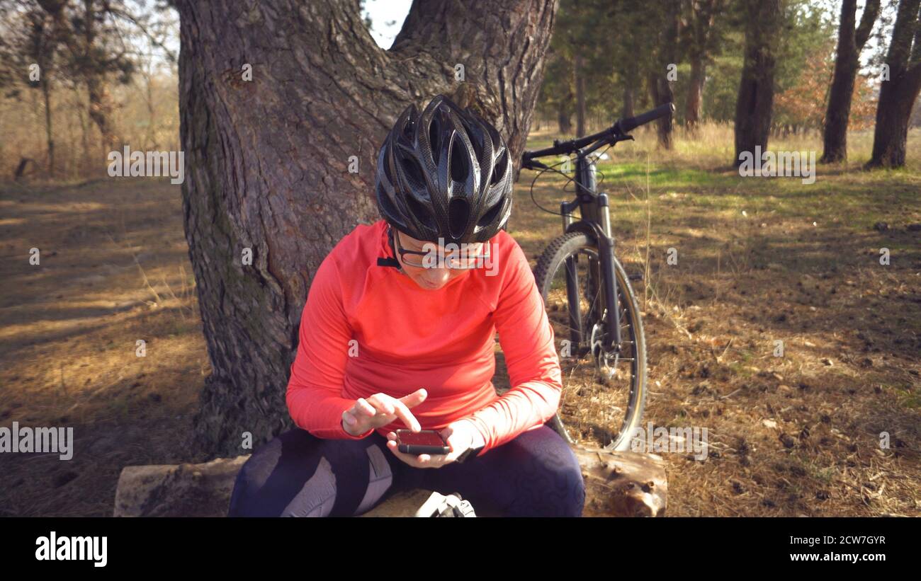Caucasian sport cyclist woman sport off road bike park near tree. woman ...