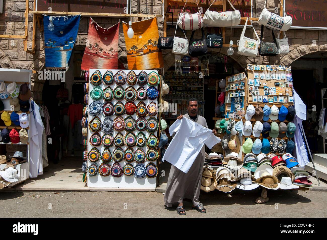 A souvenir and textile salesman tries to entice customers into his ...