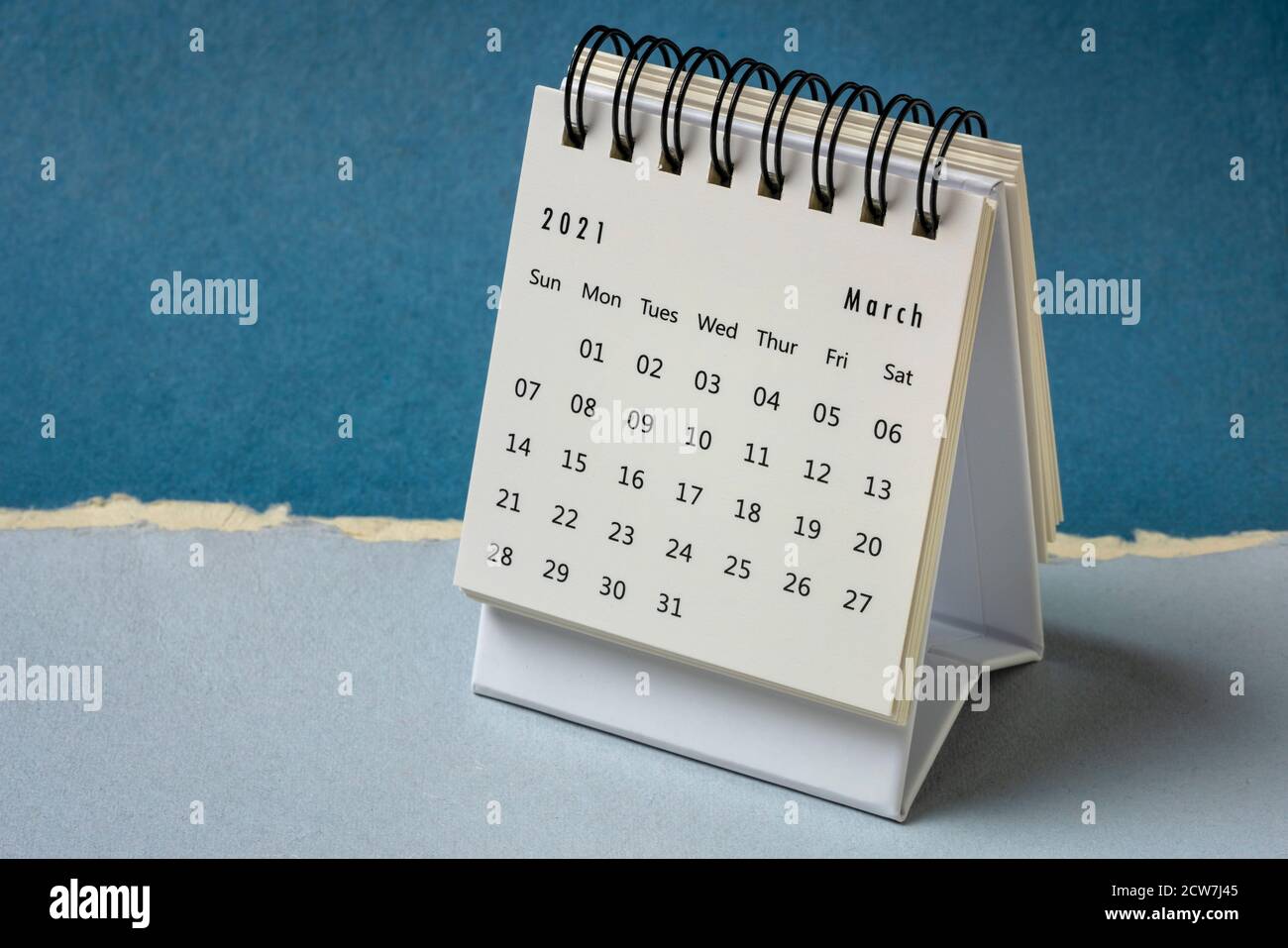 March 2021- spiral desktop calendar against colorful handmade paper ...