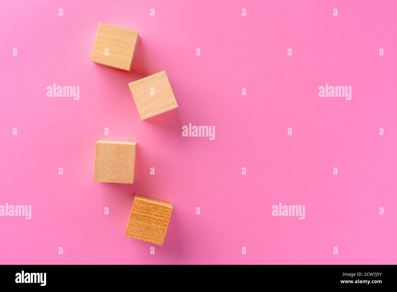 Top view of toy wooden blocks on pink Stock Photo - Alamy