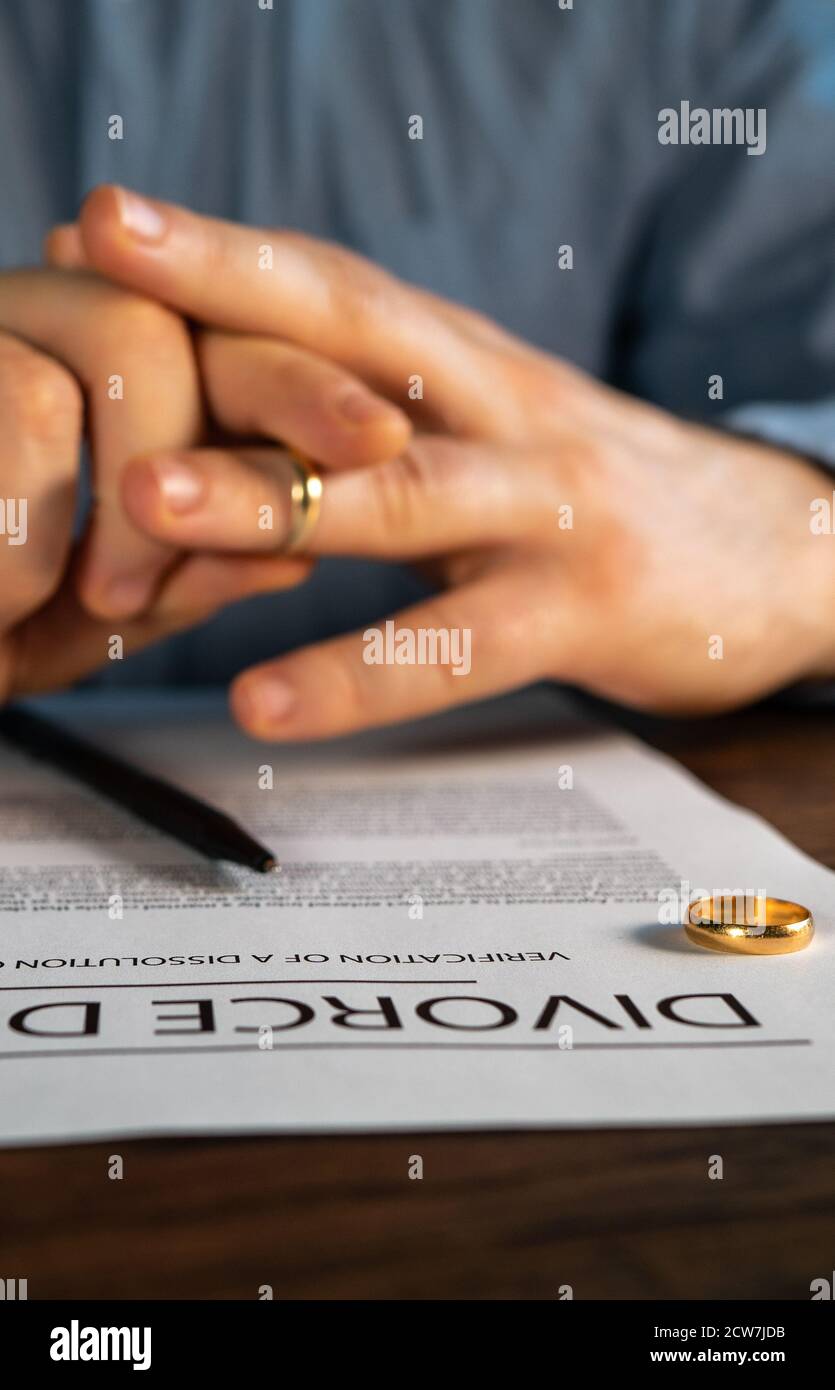 Man takes off his wedding ring from his finger Stock Photo - Alamy