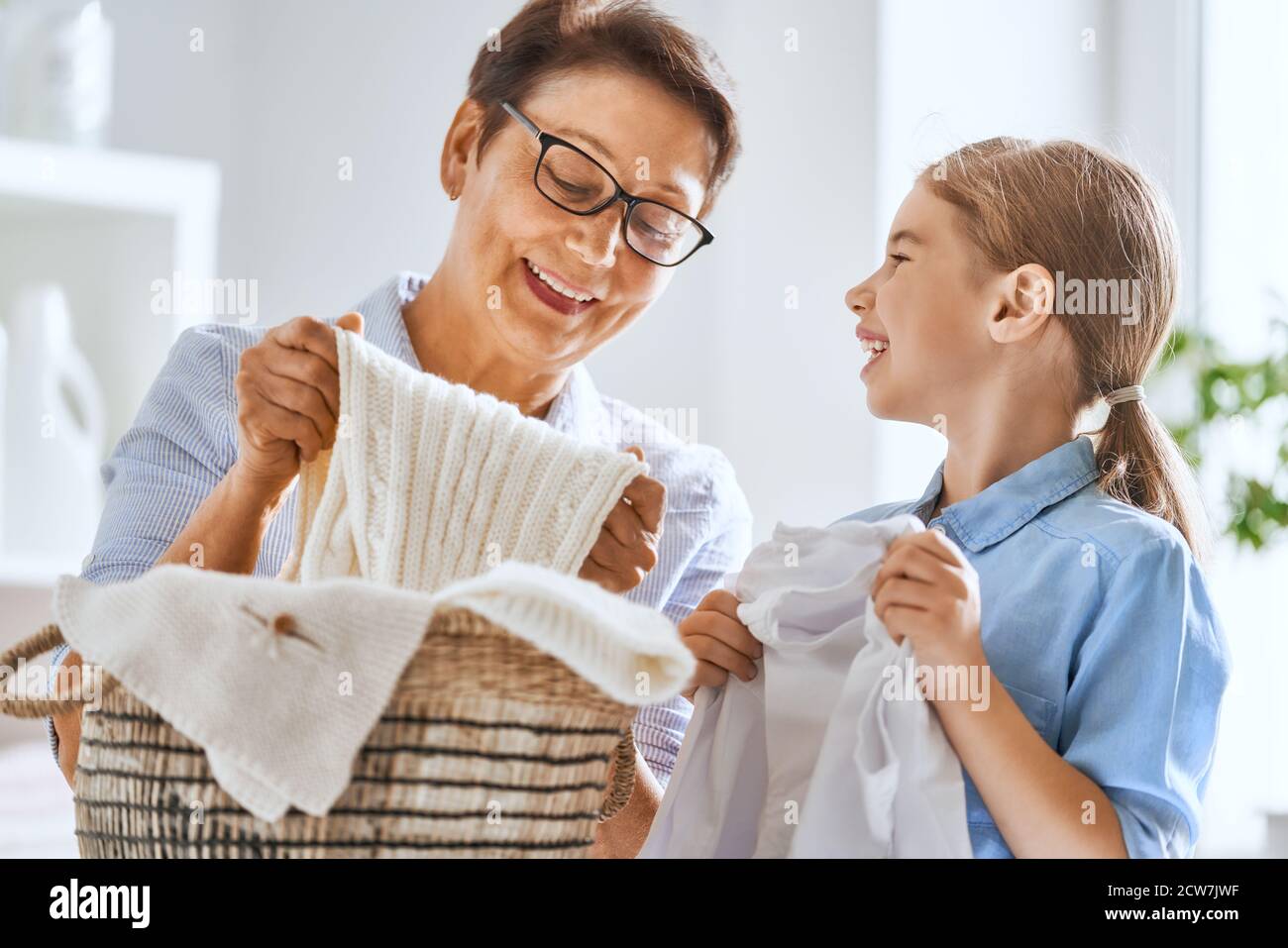 Beautiful women and child girl little helper are having fun and smiling ...