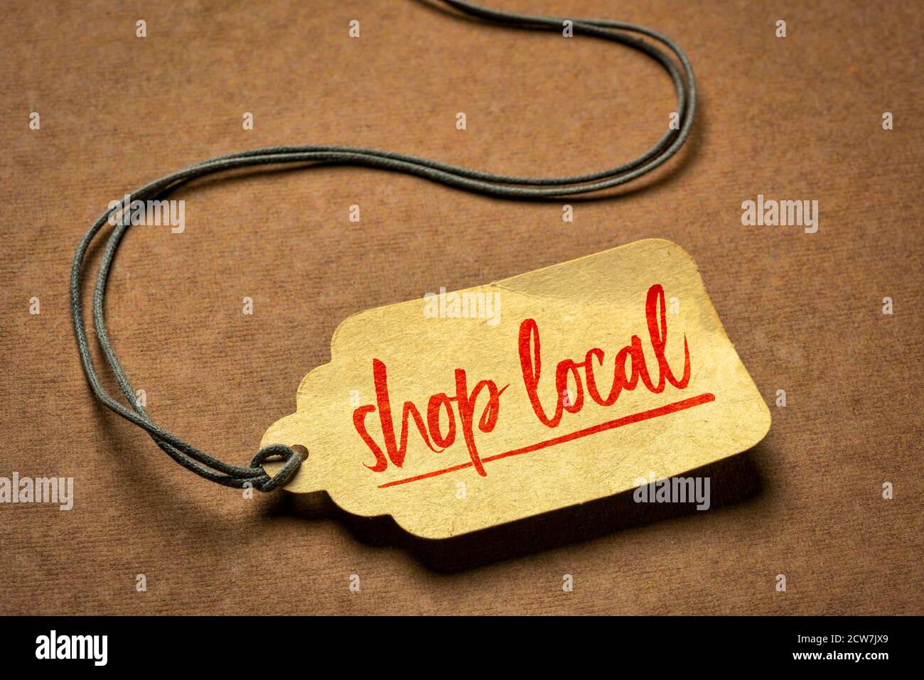 shop local sign a paper price tag against brown paper background ...