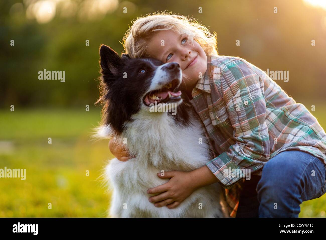 Little boy playing with his dog outdoors in the park Stock Photo - Alamy