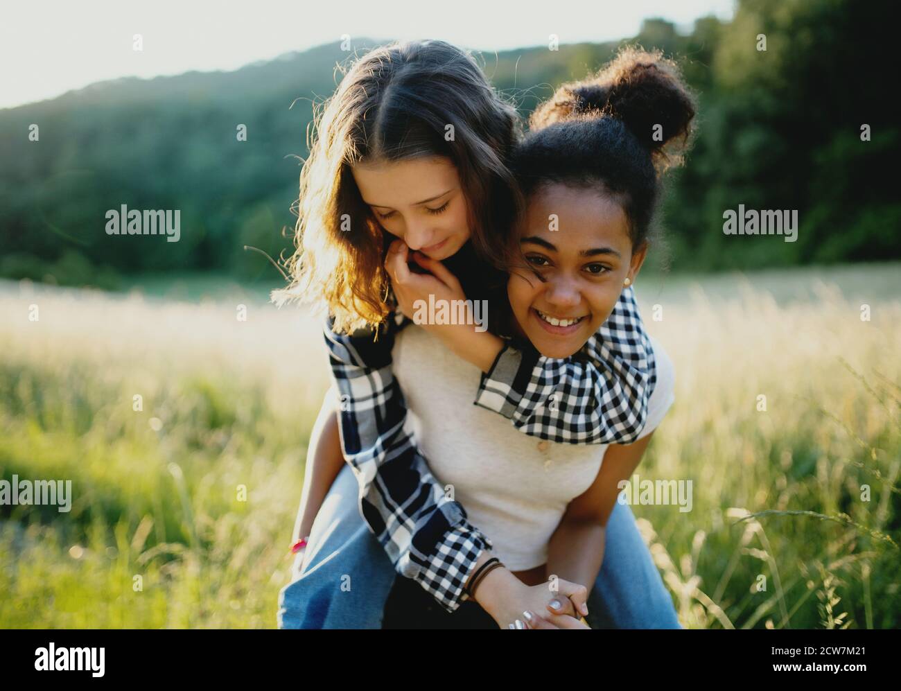 Front view of young teenager girls friends outdoors in nature, having ...