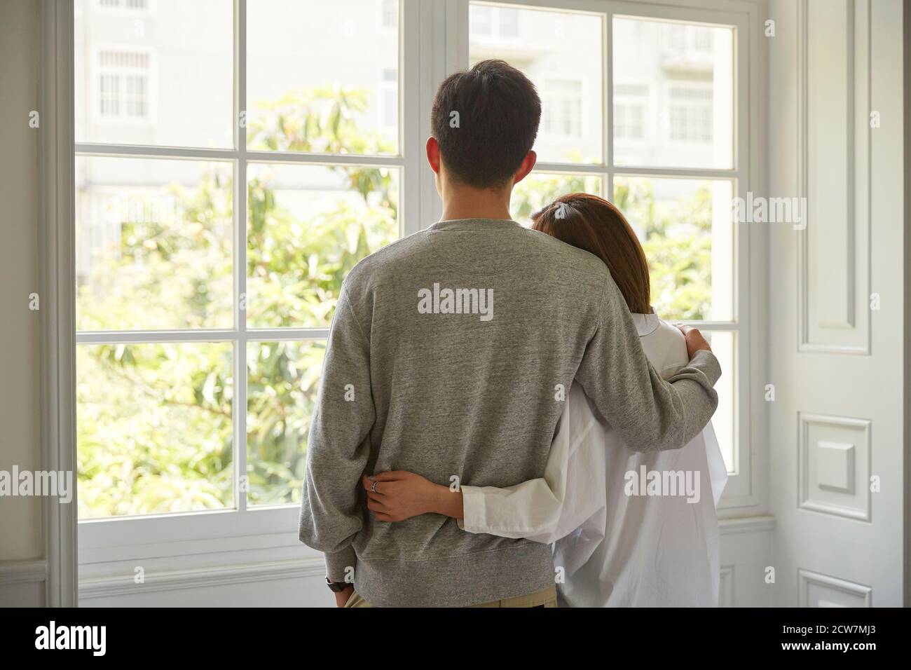 Rear view of a couple looking out of the window hi-res stock ...