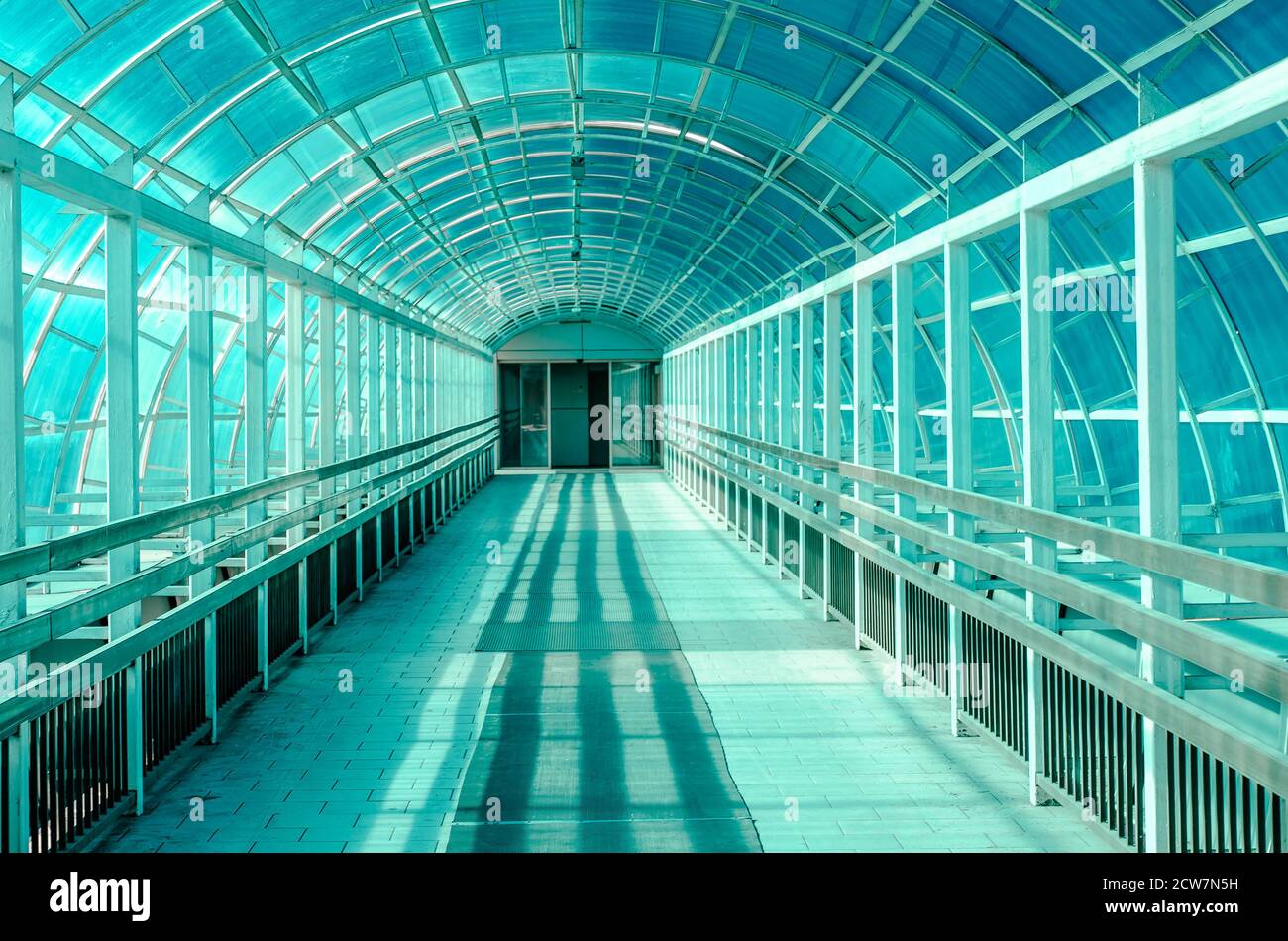 indoor elevated pedestrian bridge in the city, inside view. Tunnel for ...