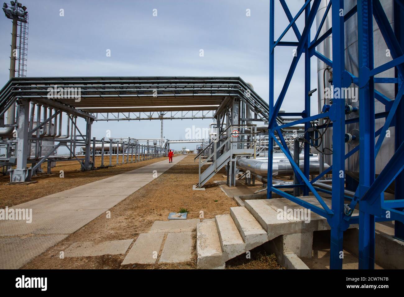 Oil refinery and gas processing plant. Pipelines and mast on grey sky ...