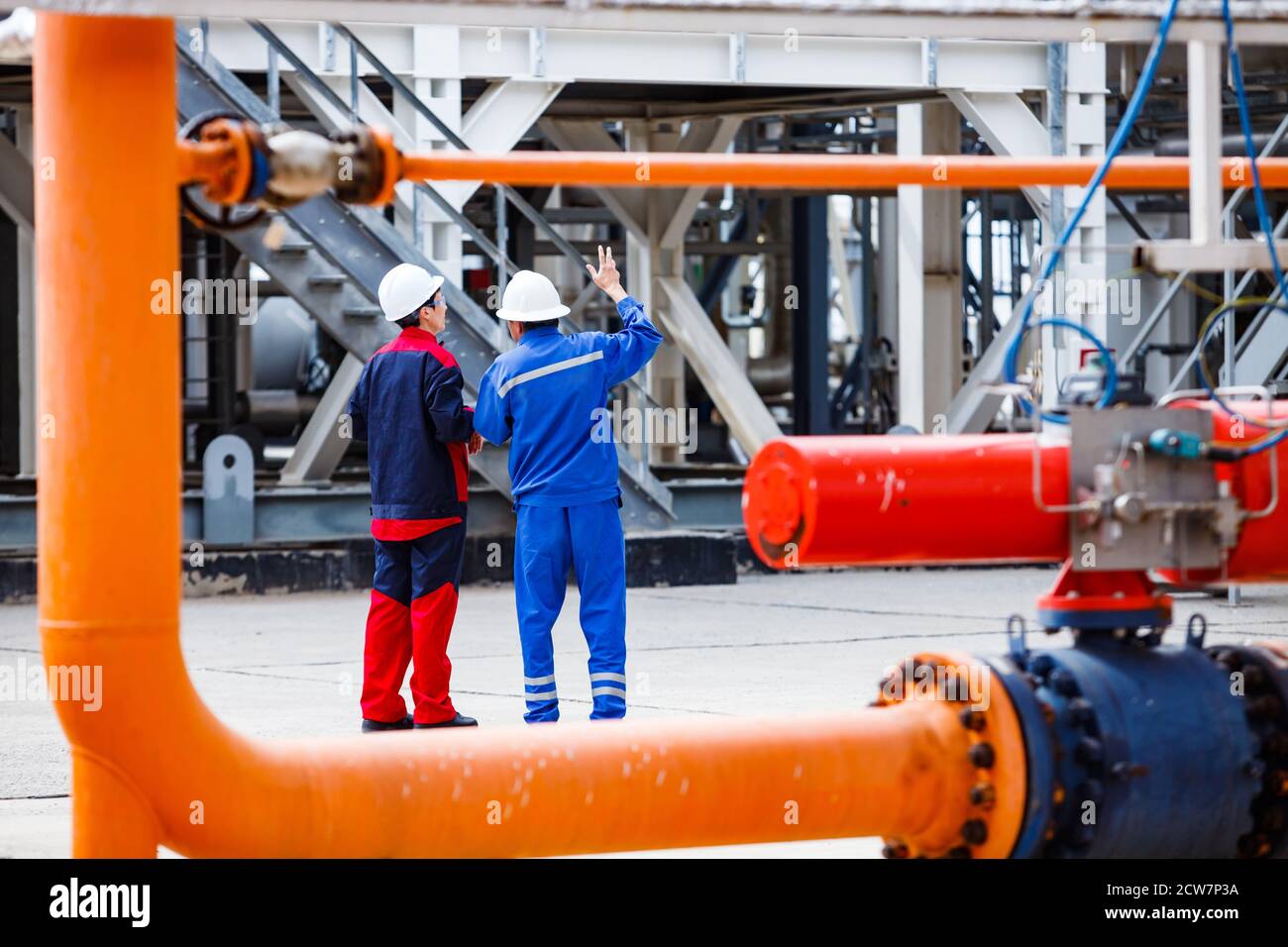 Zhaik-Munai oil deposit, Kazakhstan. Oil refinery plant. Two engineers ...