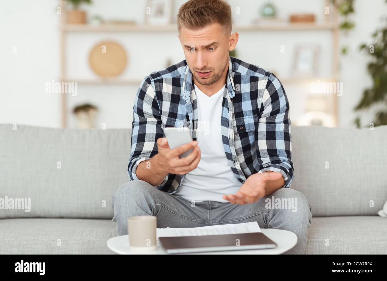 Mobile surprise man home hi-res stock photography and images - Alamy