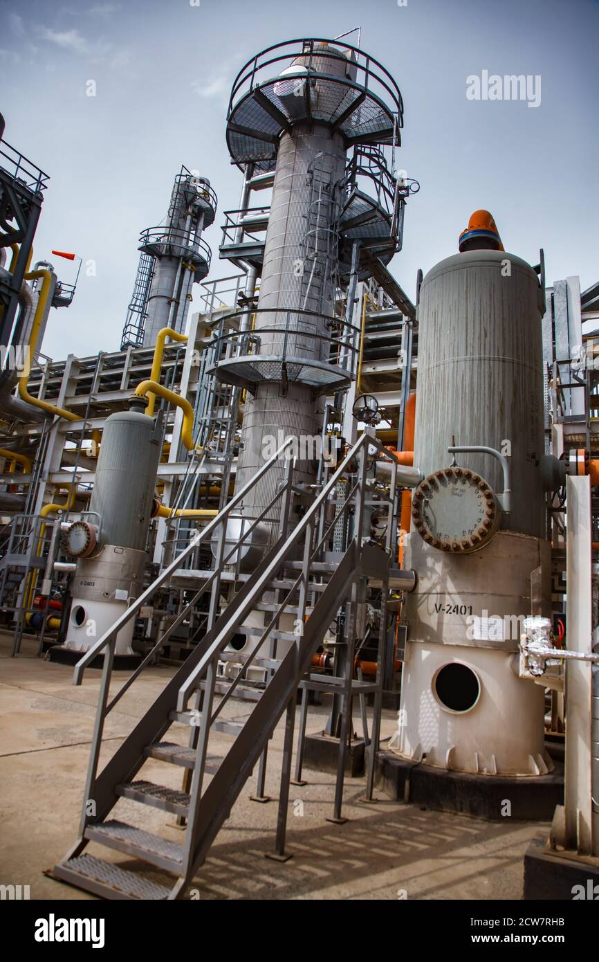 Oil refinery and gas processing plant. Grey metal distillation towers ...