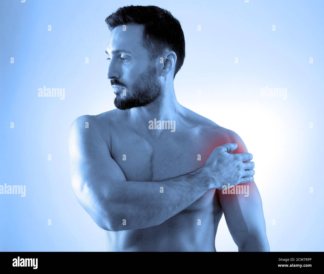 Man holding his sore shoulder Stock Photo - Alamy