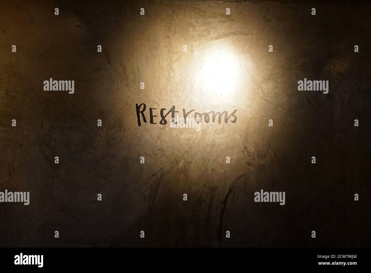 Restrooms text with lighting on concrete cement loft wall Stock Photo ...