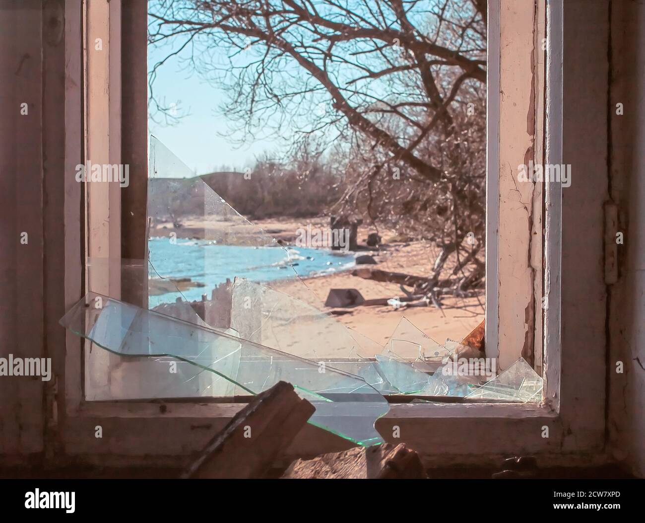 Inside view. Broken window of an old building from which you can see ...