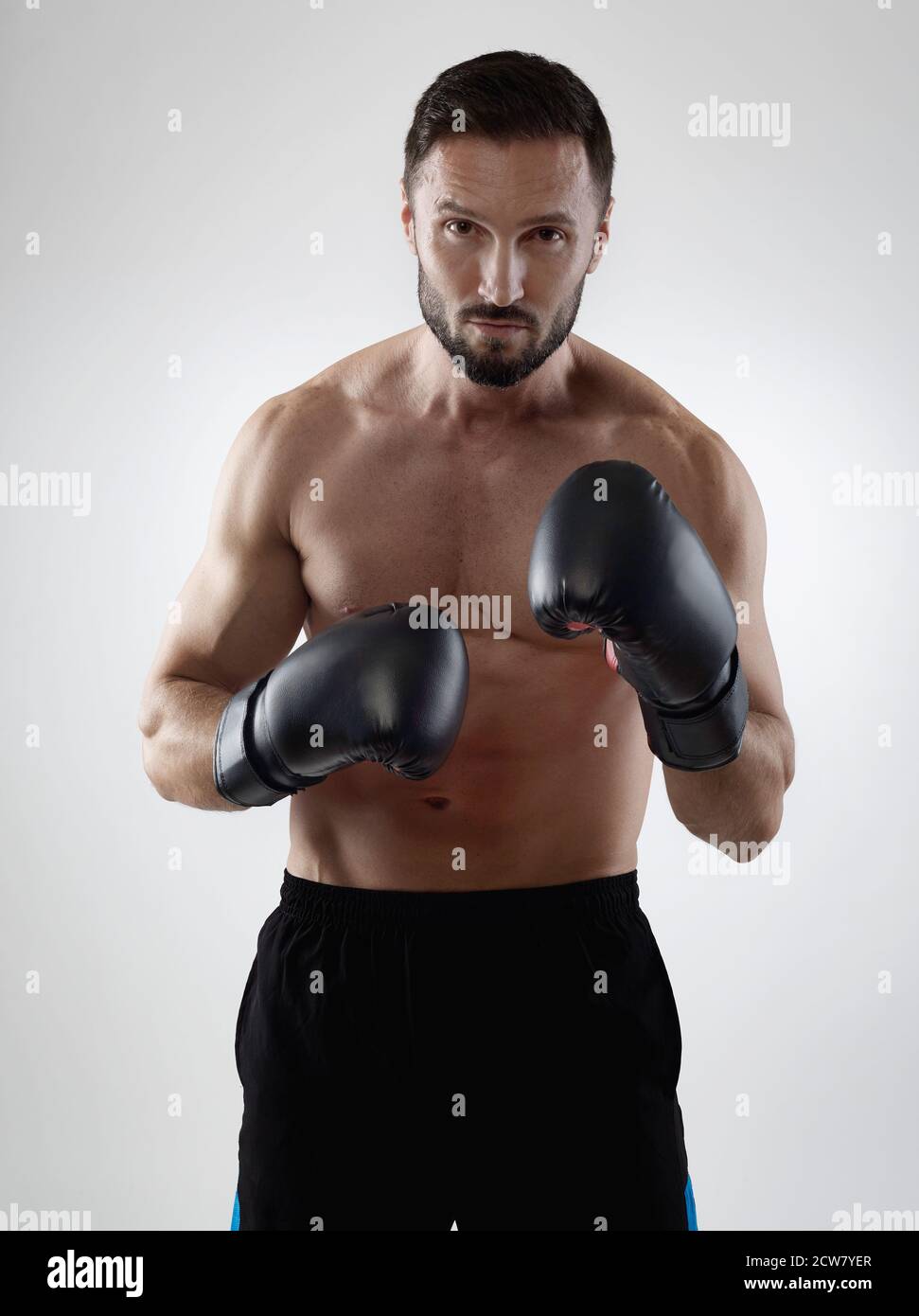 Confident muscular boxer with boxing gloves Stock Photo - Alamy