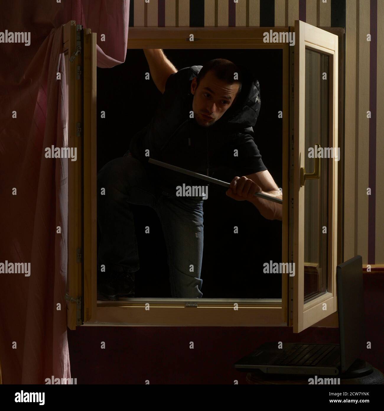 Man breaking-in the house through the window Stock Photo - Alamy