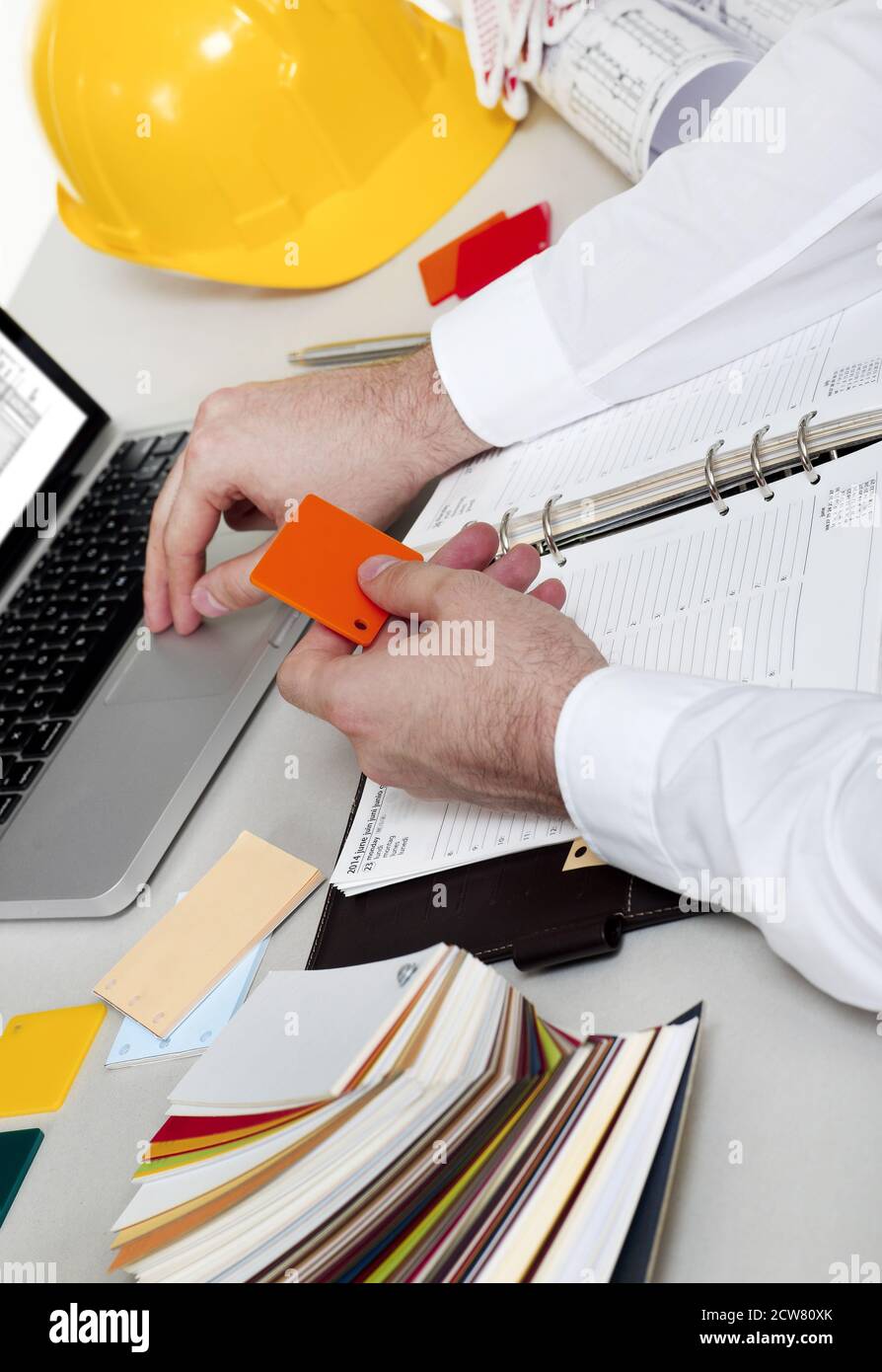 Construction engineer choosing the color Stock Photo - Alamy